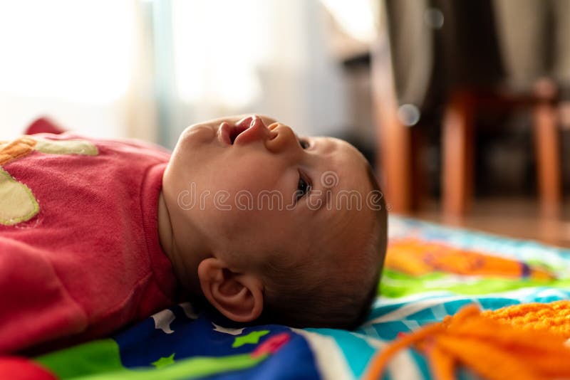Newborn Baby Resting Relaxed Face Up on a Carpet Stock Photo - Image of ...