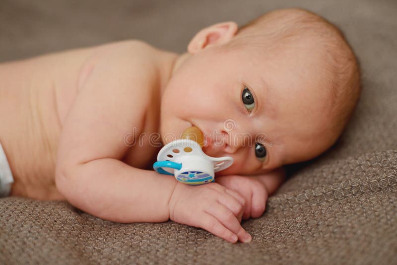 Newborn with dummy stock image. Image of expression, cute - 47031903
