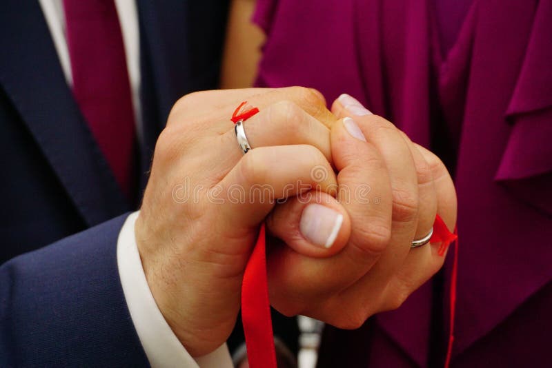 Newly Engaged Couple Holding Hands with a Ribbon Stock Photo - Image of ...