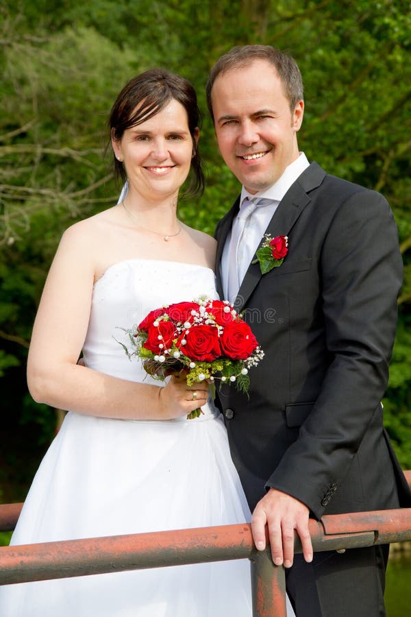 Newly Married Couple with Red Roses Stock Image - Image of dark, proud ...