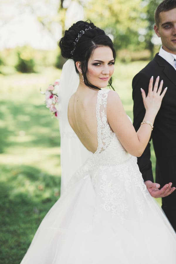 Newly Married Couple Running and Jumping in Park while Holding Hands ...