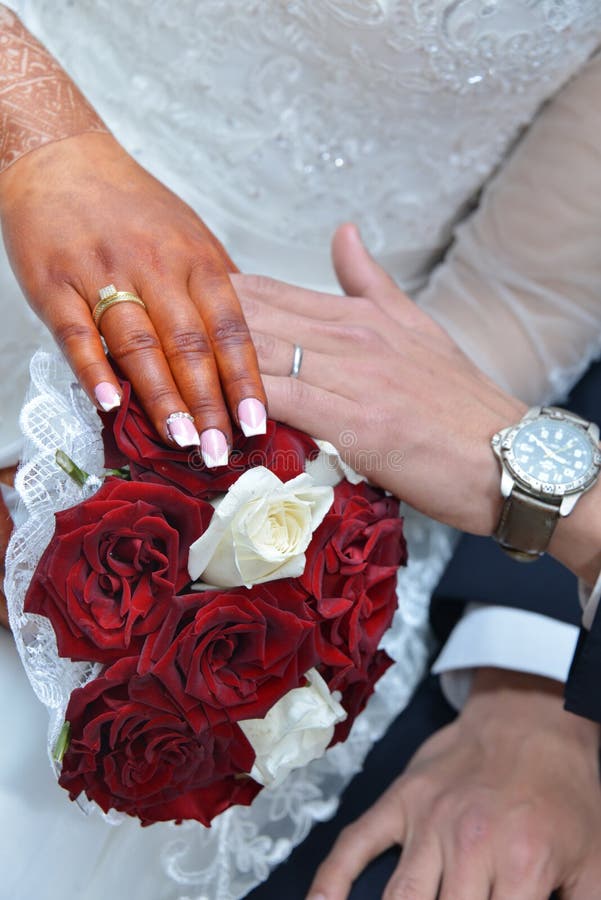 Two Hands with Gold Wedding Rings on Flower Bouquet Stock Photo - Image ...
