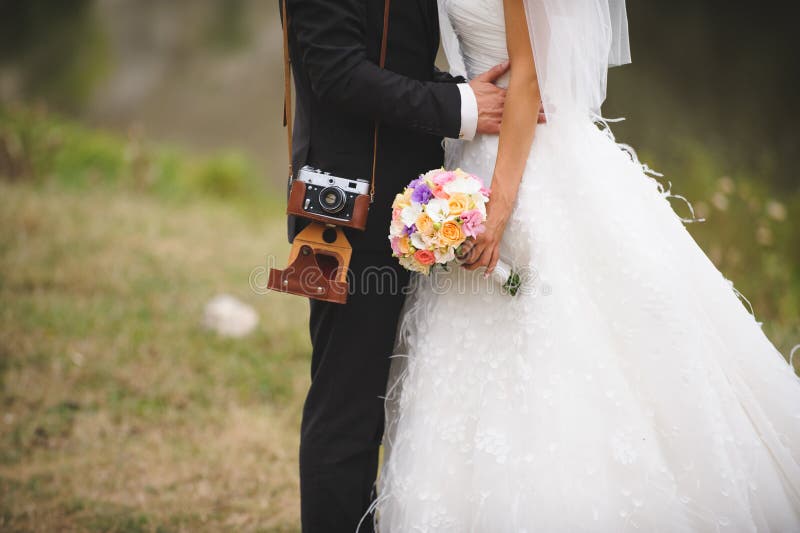 Newlyweds with Camera and Bouquet Stock Image - Image of emotion ...