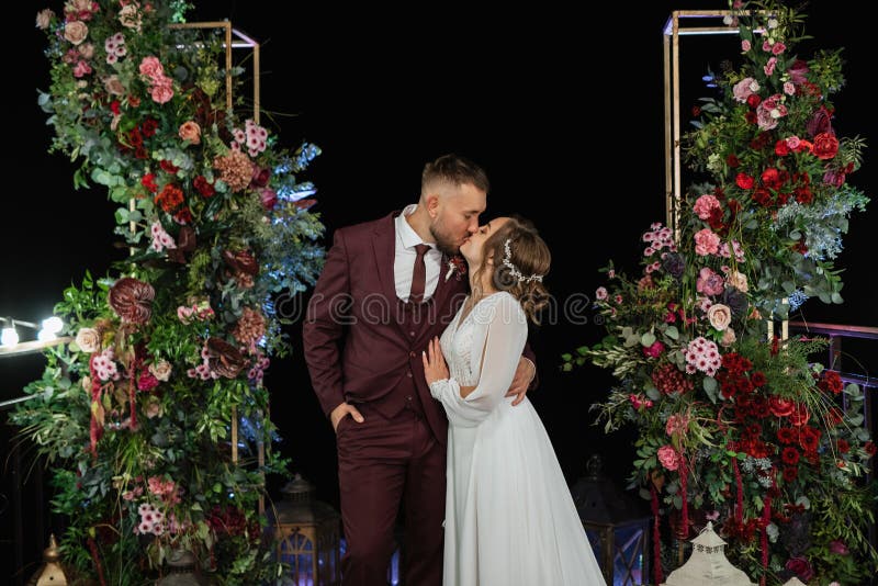 Newlyweds in the Evening on the Wedding Arch Stock Image - Image of ...