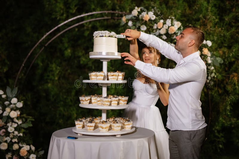Newlyweds Happily Cut and Taste the Wedding Cake Stock Photo - Image of ...