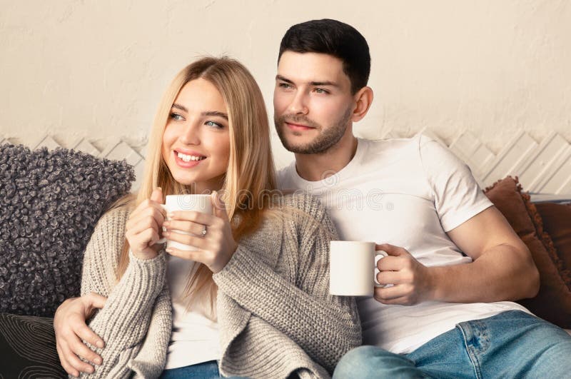 Newlyweds with Hot Tea Cuddling on Sofa Indoors Stock Image - Image of ...