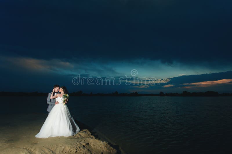 Newlyweds on the River Bank at Night Stock Photo - Image of beautiful ...