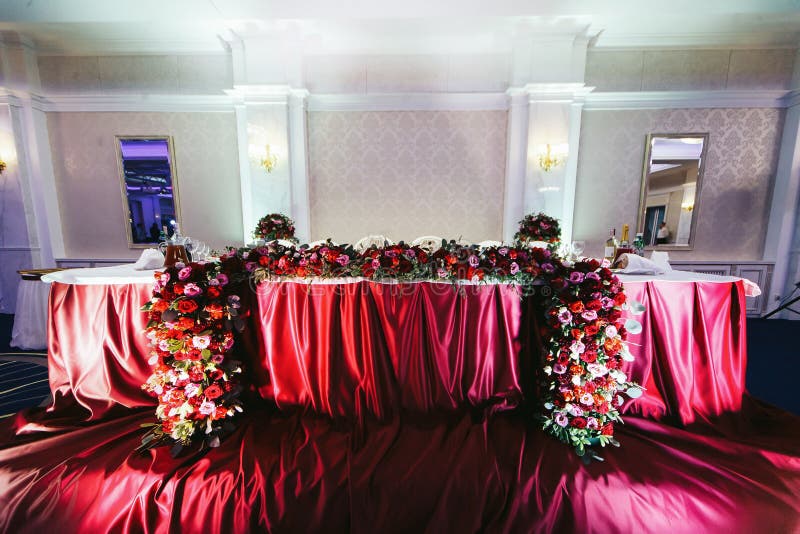 Newlyweds Table with the Red Silk Cloth Decorated with Roses Stock ...