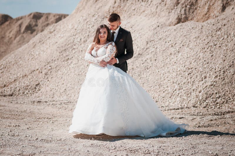 Newlyweds Walk and Hug in a Sandy Quarry Stock Image - Image of ...