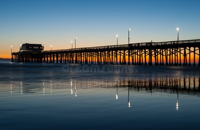 Newport beach pier sunset stock image. Image of sunset - 32072235
