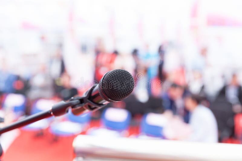 News Conference. Microphone in Focus Against Blurred Audience. Stock ...