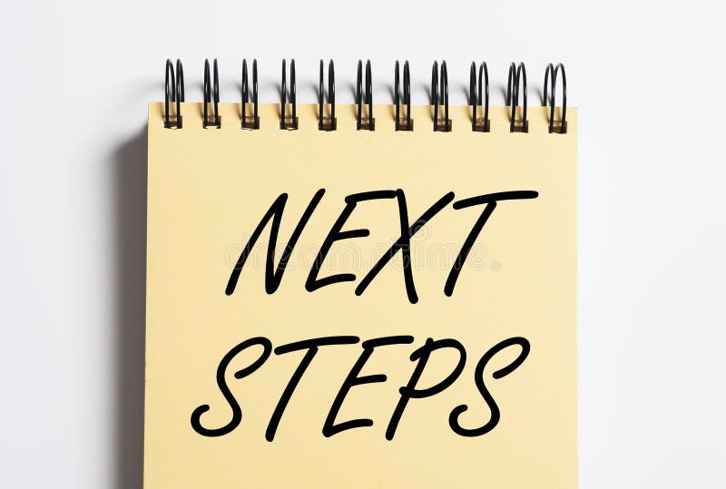 Next Step Phrase on Yellow Notebook on Blue Table with Male Hand Stock ...
