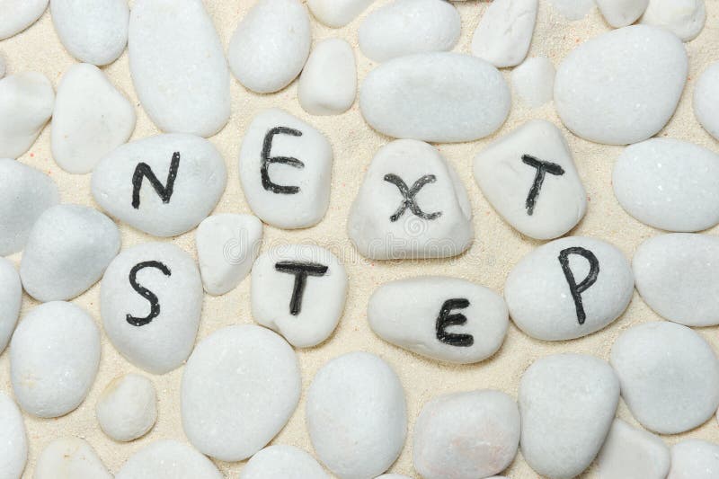 Next step words on pebbles stock image. Image of sandy - 26702395