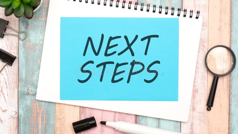 NEXT STEPS on Blue Paper Composition with Stationery on Color ...