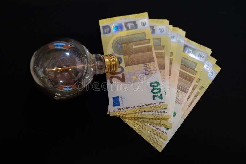 Next To a Light Bulb is a Stack of 200 Euro Banknotes Stock Image ...