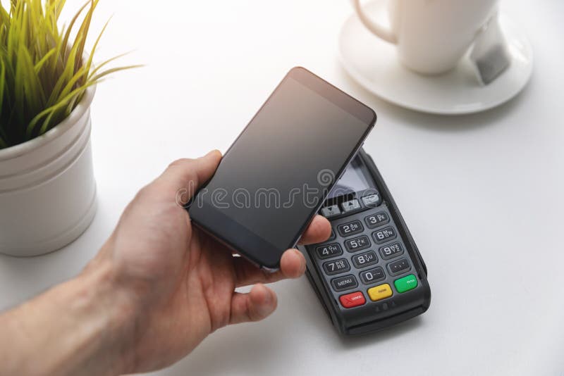 Nfc Contactless Payments - Hand Holding Phone Above Payment Terminal ... Nfc Contactless Payments - Hand Holding Phone Above Payment Terminal ...