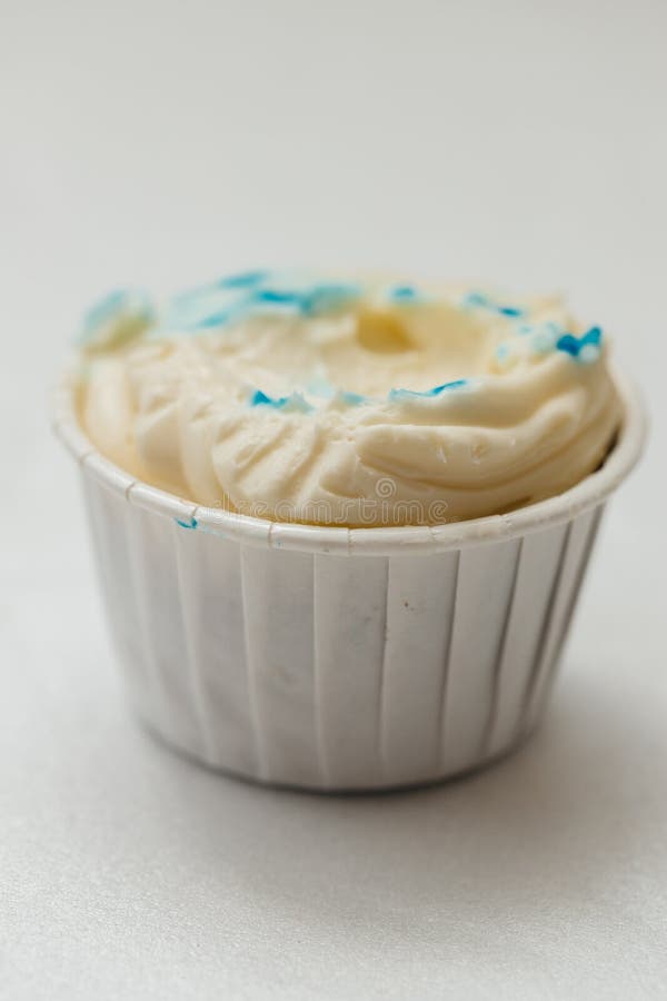 A Nibbled or Spoiled Cream Cake in a Cardboard Basket on a White Table ...