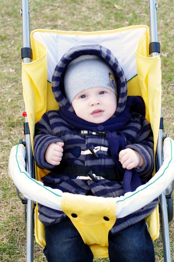 Nice Baby Outdoors on Yellow Buggy in Spring Stock Photo - Image of ...