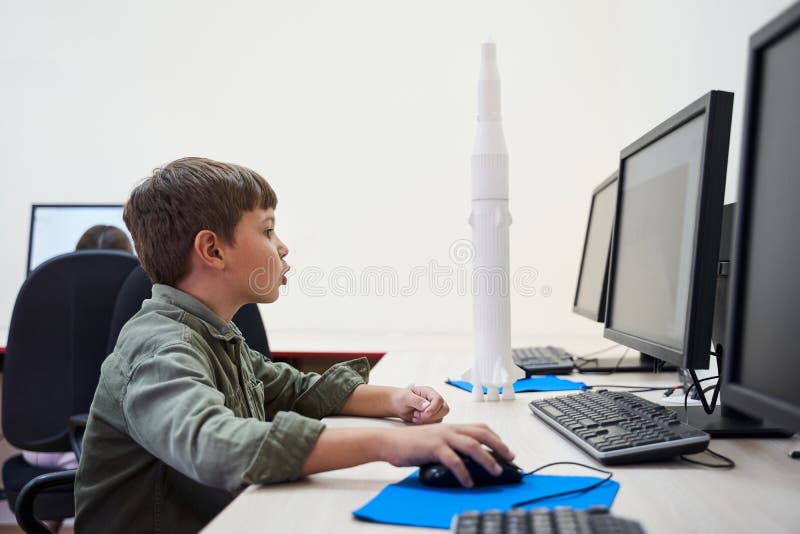Nice Caucasian Concentrated Boy Using Computer and the Computer Mouse ...