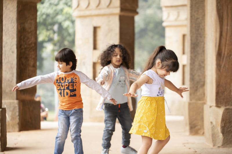 Nice Children Playing and Having Fun while Spreading Their Hands Apart ...