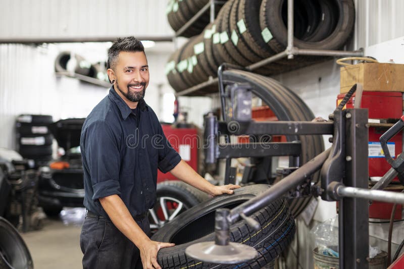 Nice and Cool Mechanic Changing Car Tire at Work Stock Photo - Image of ...