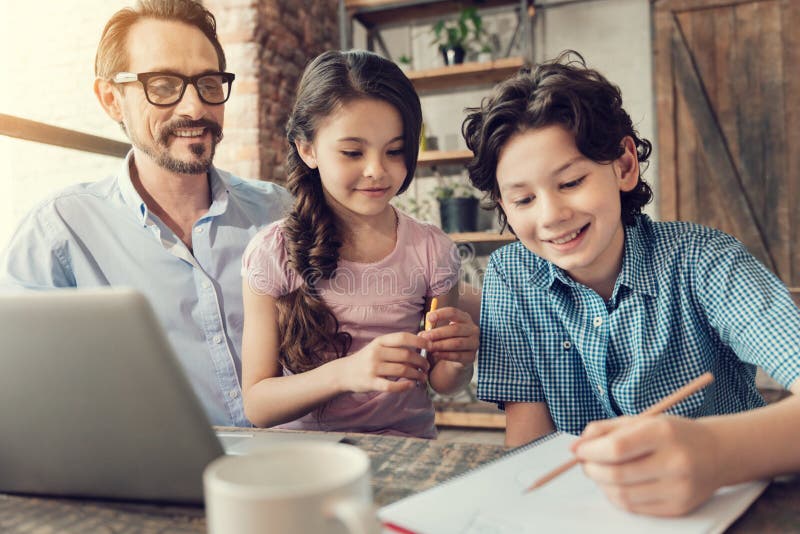 Nice Delighted Children Doing Homework Together Stock Image - Image of ...