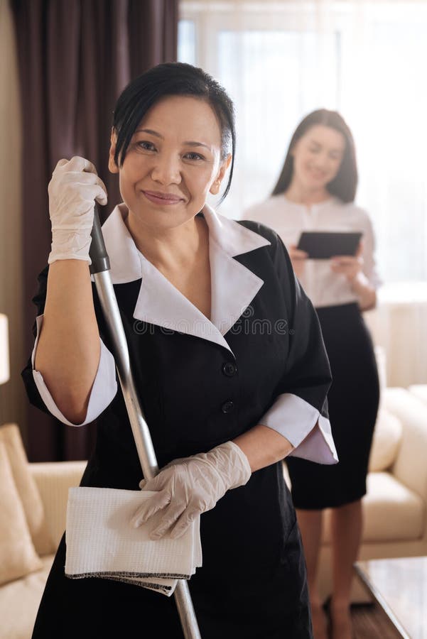 Nice Delighted Hotel Maid Holding a Mop Stock Photo - Image of concept ...
