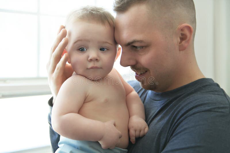 The Father Hugging Her Baby with a Sad Face and Eyes Stock Image ...