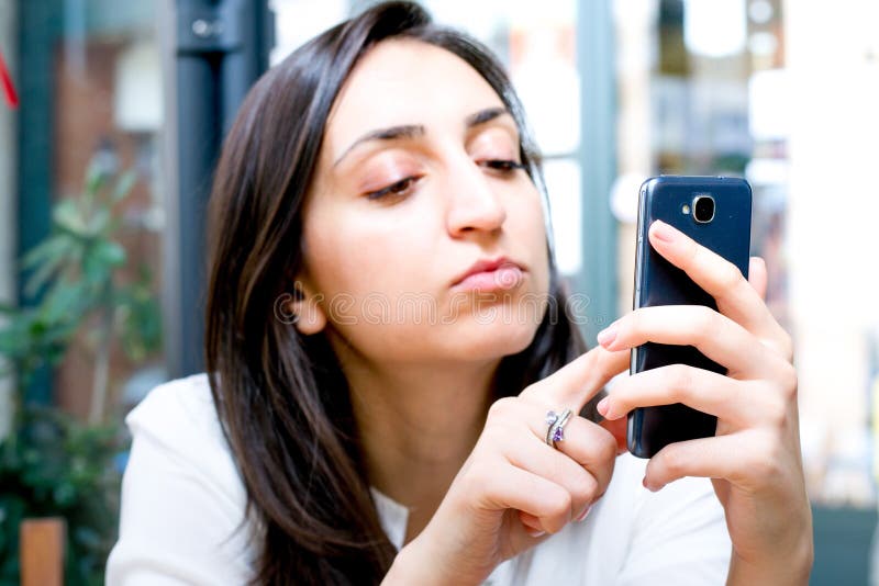 Nice Girl Looking at Her Phone and Touching the Screen Stock Image ...