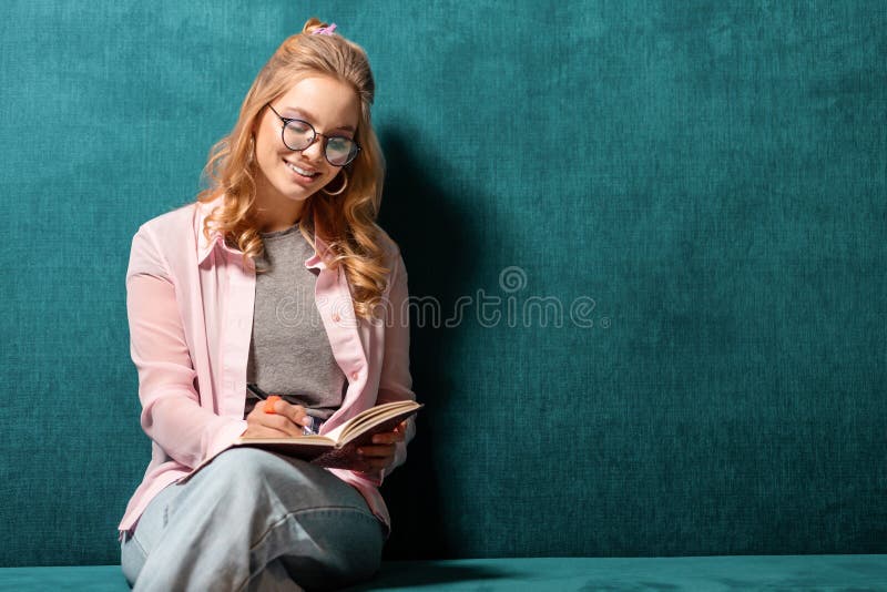Nice Girl Making Notes in the Book on the Most Interesting Paragraphs ...