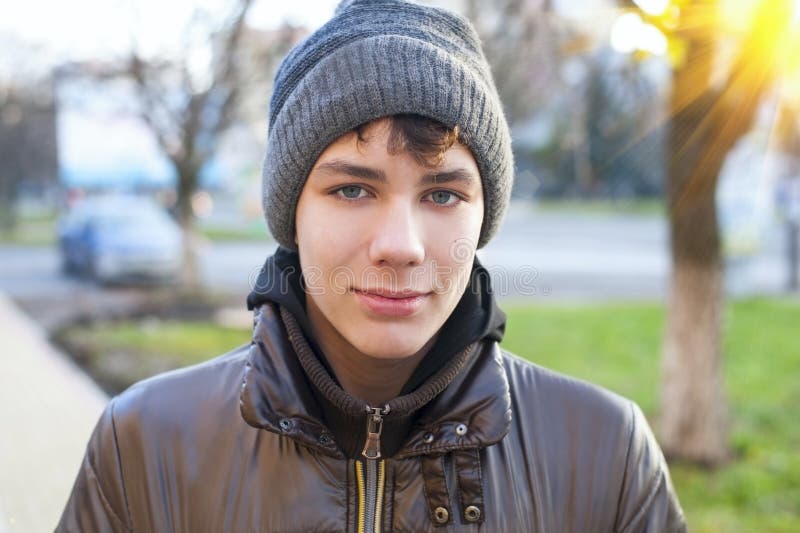 A Nice Guy in a Warm Hat and Jacket Walks Around the City at Sunset ...