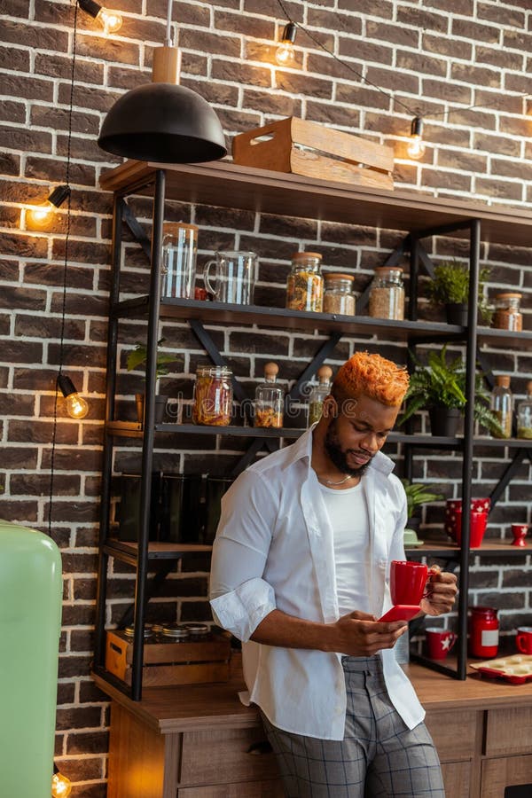 Nice Handsome Man Standing Near the Shelf Stock Photo - Image of gadget ...