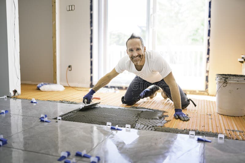 Nice Handyman Install Tile on the Floor Stock Photo - Image of ...