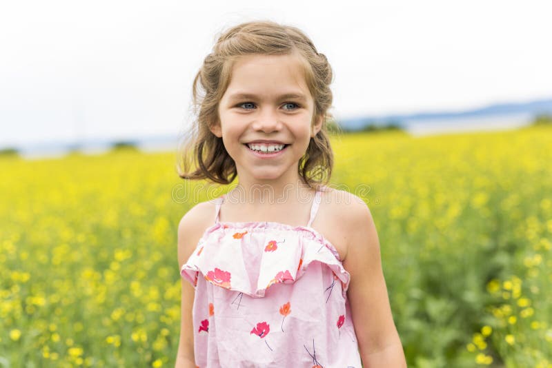 Happy Girl in a Field of Yellow Flowers Stock Image - Image of floral ...
