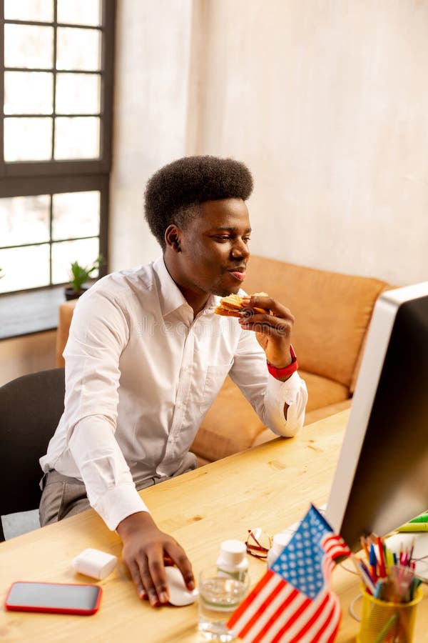 Nice Hard Working Man Eating at Work Stock Image - Image of computer ...