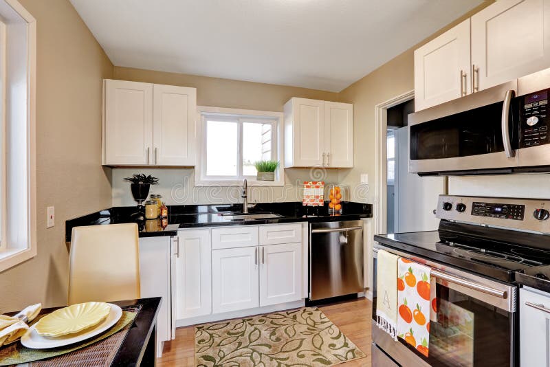 Nice Kitchen with Black Counters. Stock Image - Image of wall, shiny ...