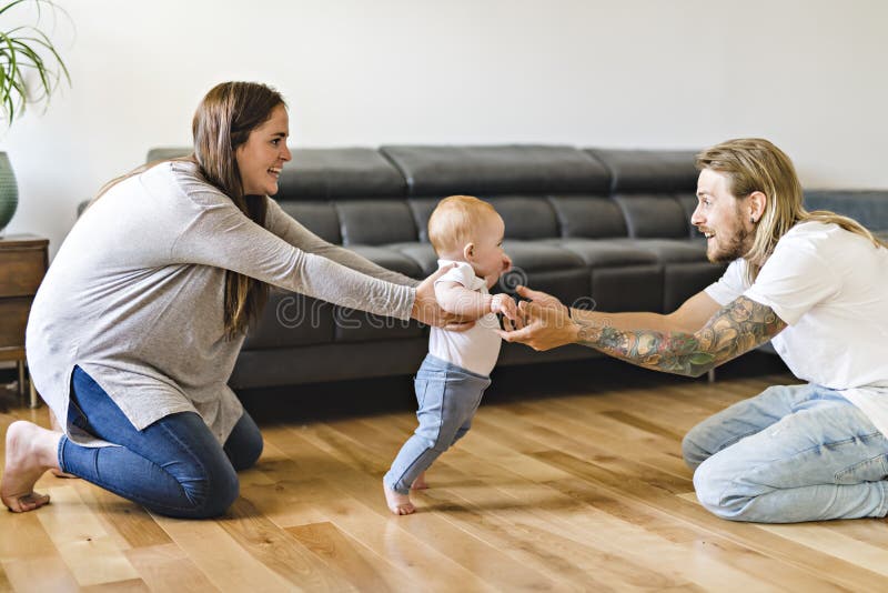 Parent Help Baby Daughter Take First Steps at Home Stock Image - Image ...