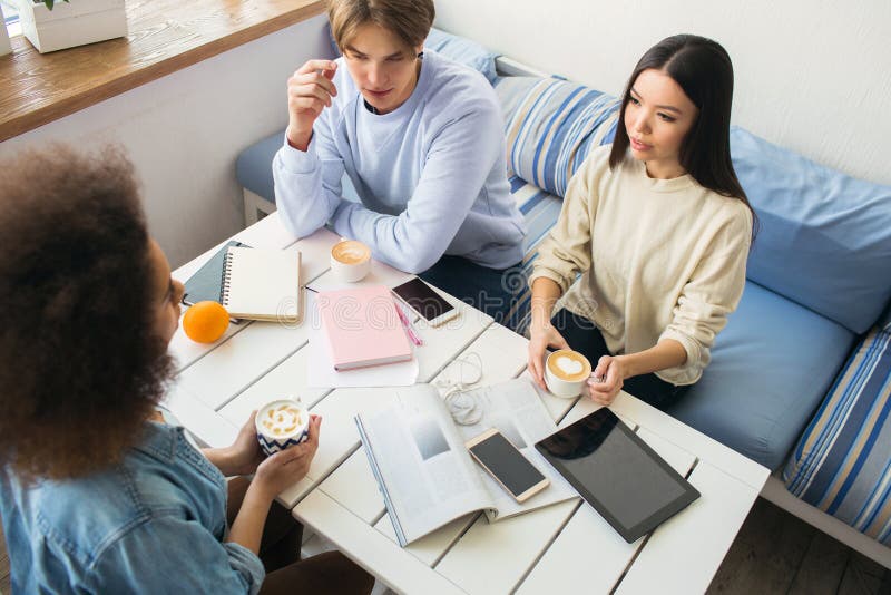 Nice Picture of Three Students Sitting at the Table. There are Lots of ...