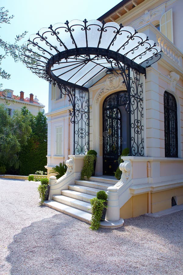 Nice Porch of the House with Painted Flower Beds and a Chair Stock ...
