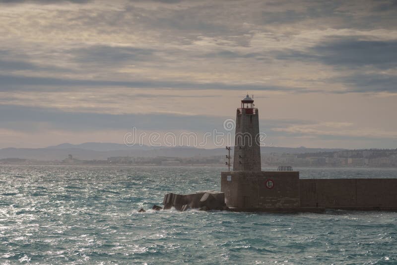 Nice Port Lighthouse in the Harbor at Sunset with Uncalm Sea Stock ...