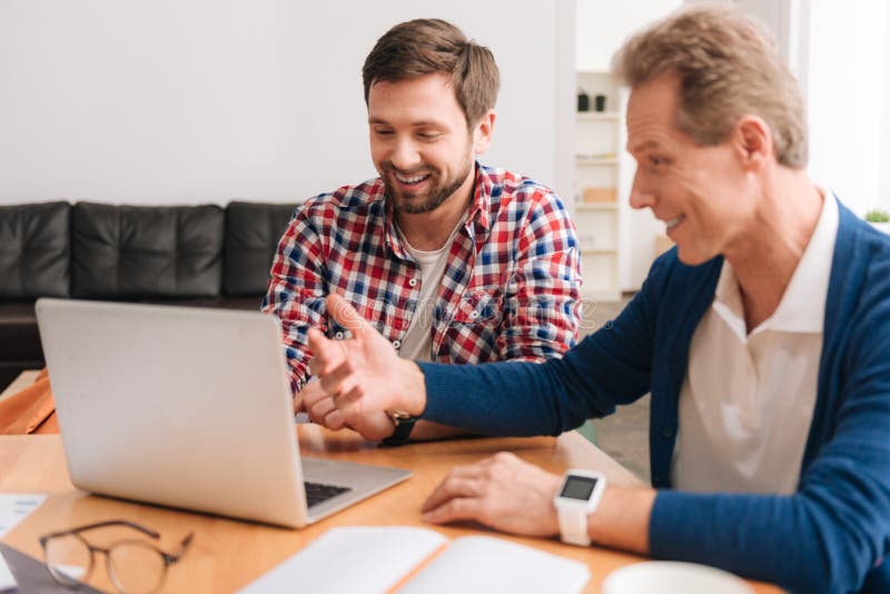 Nice Positive Men Using a Laptop Stock Image - Image of interaction ...