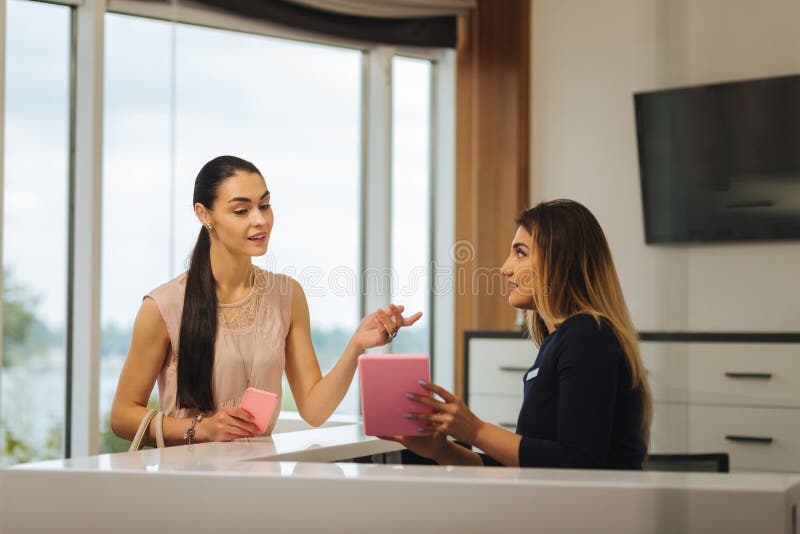 Nice Professional Administrator Showing a Tablet To the Client Stock ...