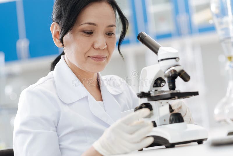 Nice Professional Biologist Looking at the Microscope Slide Stock Photo ...