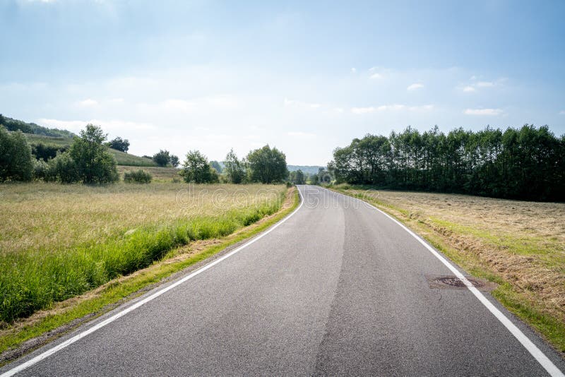 Nice Road in the Landscape with Grass, Trees and Blue Sky Stock Image ...