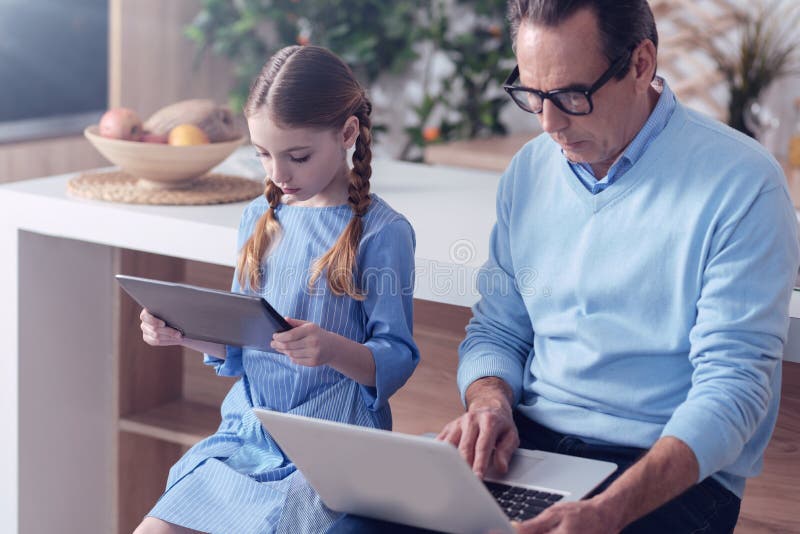 Nice Serious Father and Daughter Sitting Together Stock Photo - Image ...