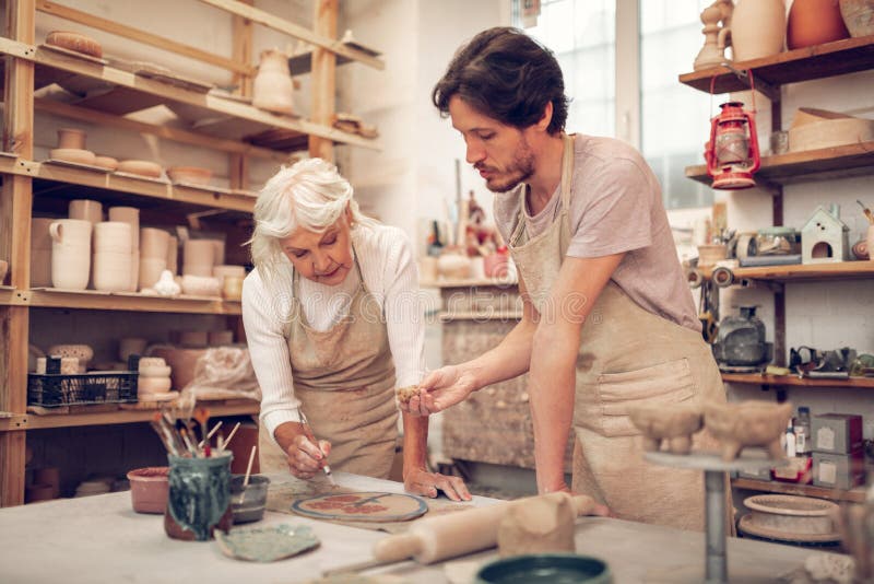 Nice Skilled Young Man Helping His Master Stock Image - Image of ...