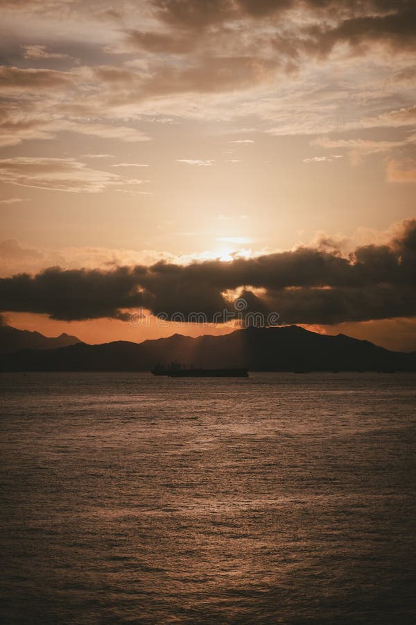 Sunset with Crepuscular Rays on the Beach with Waves Stock Photo ...
