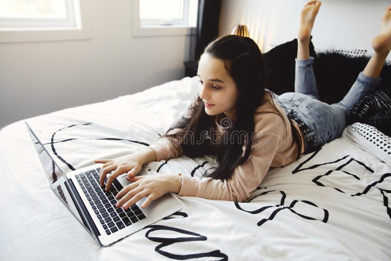 Nice Teenage Girl Using a Computer in Her Bedroom. Stock Photo - Image ...
