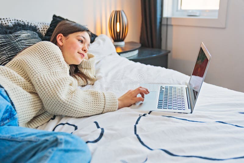 Nice Teenage Girl Using a Computer in Her Bedroom. Stock Image - Image ...