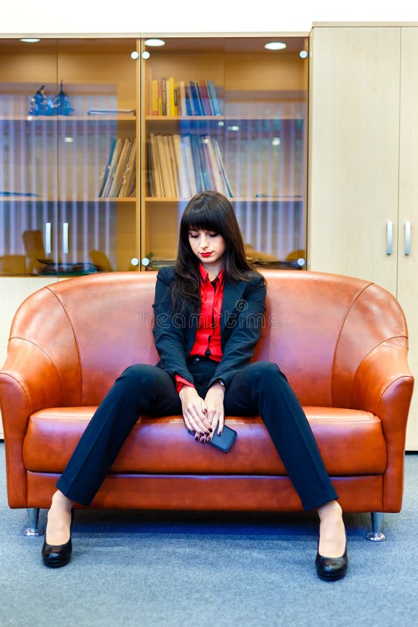 Nice Thoughtful Businesswoman in Suit Sitting in an Office on Stock ...